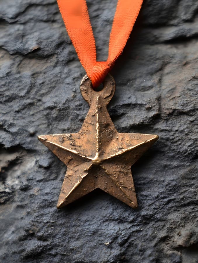 Bronze Star Medallion with Orange Ribbon on Dark Stone Background Stock ...