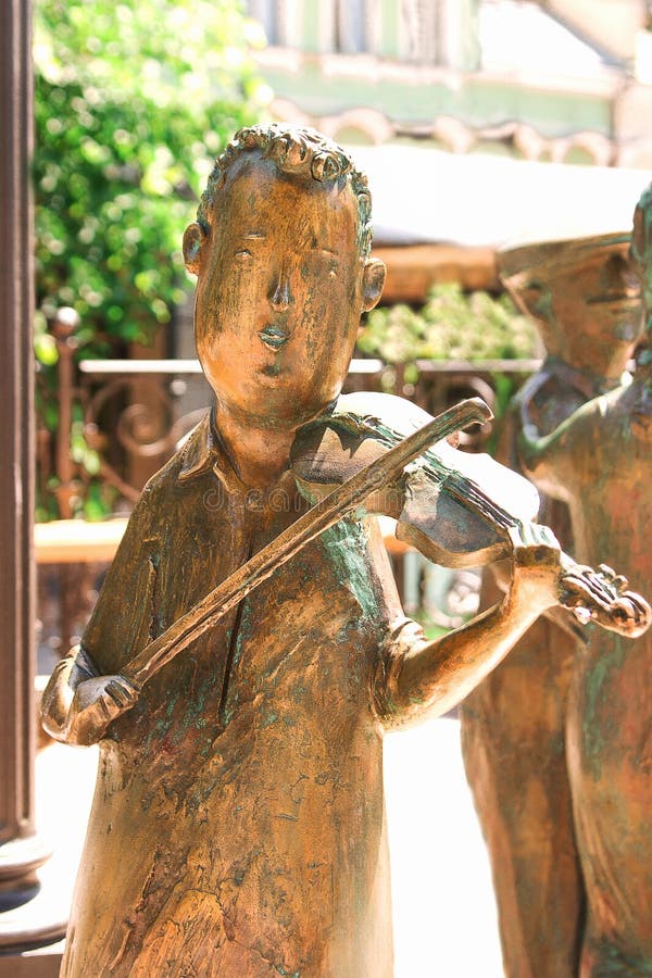 Bronze Statue of a Boy on the Street Stock Photo - Image of wood ...