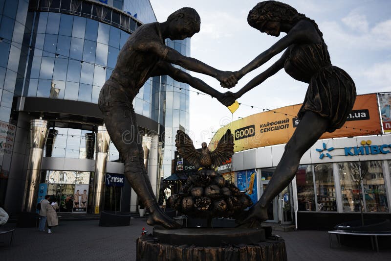 Bronze Statue of Two Figures Holding Hands in an Urban Setting ...