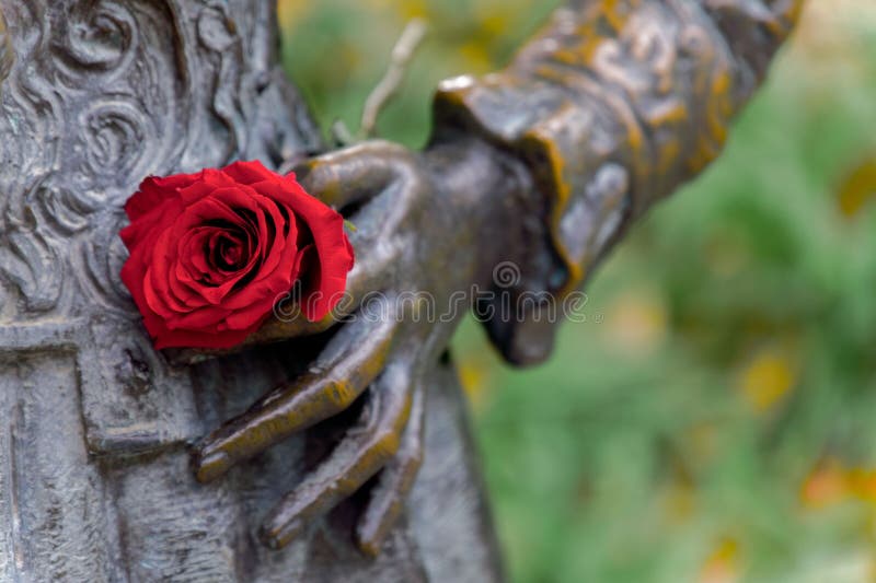 Bronze Statue of a Woman with a Red Rose in Her Hand Stock Image ...