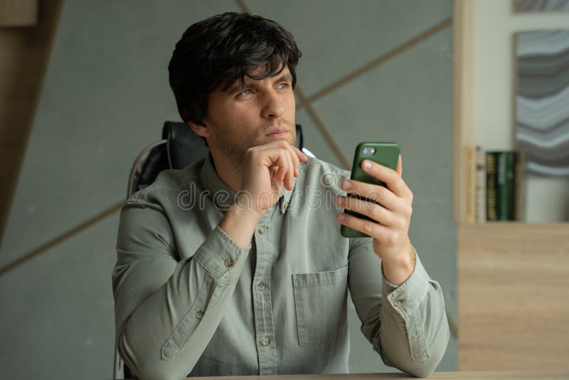 Brooding Young Man Working in a Modern Studio-office. a Person Using a ...