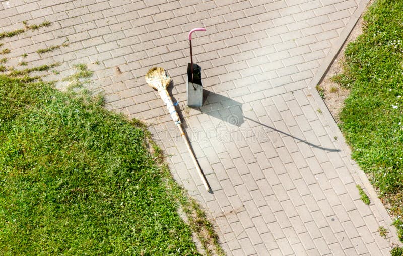 A Broom is Laying on the Ground Next To a Pole Stock Image - Image of ...