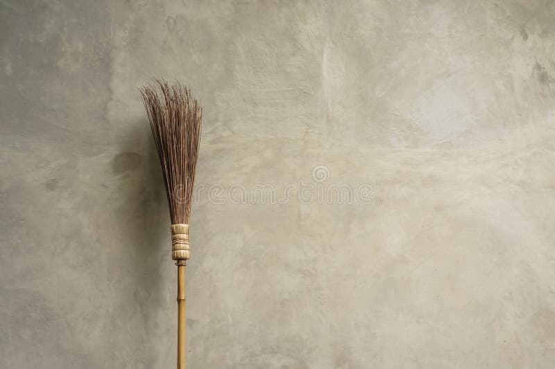 A Broom Stick with a Handle Made of Yellow Bamboo Leaning Against a ...