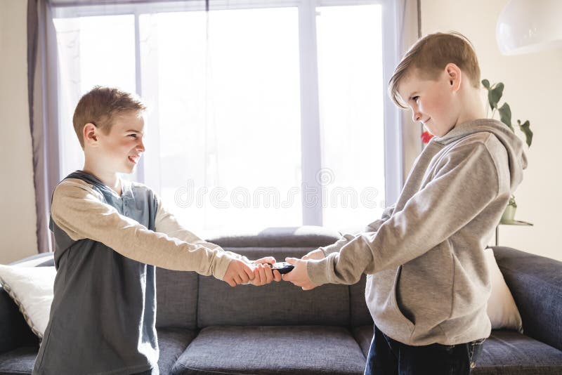 Brother Fighting Over Remote Control at Home Stock Image - Image of ...