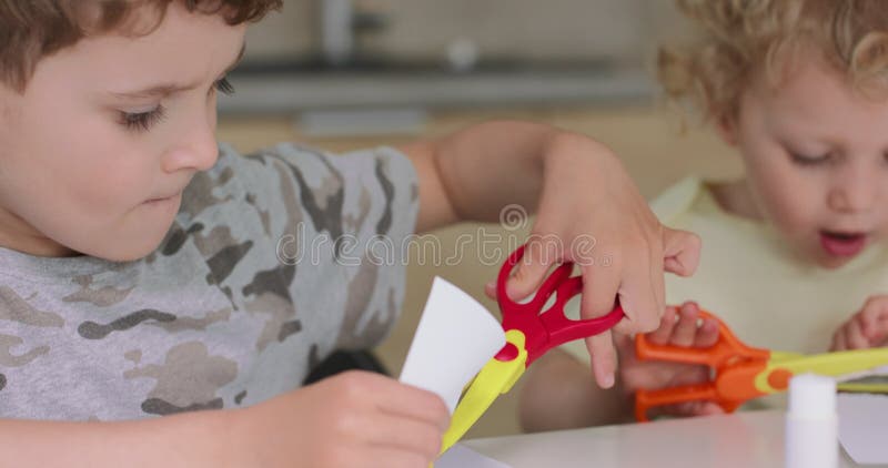 Brother and Sister are Cutting Different Objects from Paper with ...