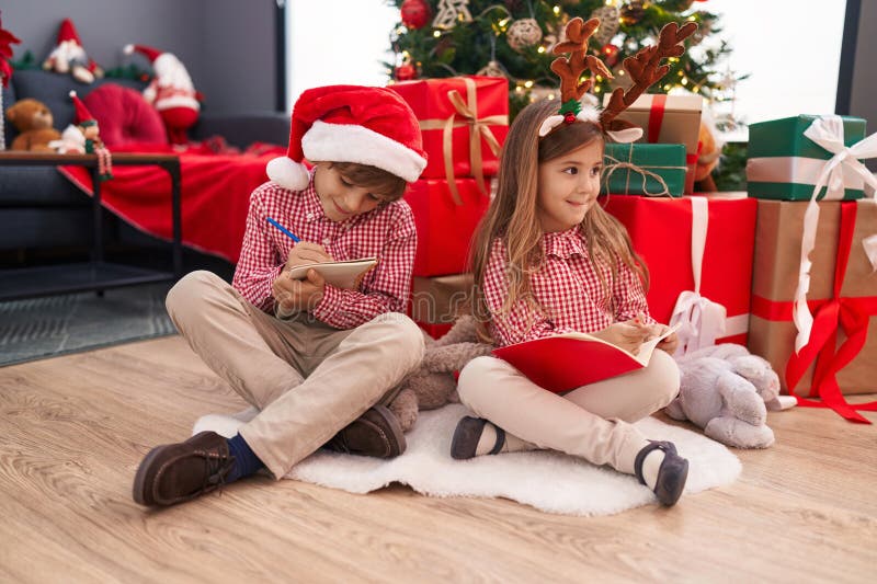 Brother and Sister Drawing on Notebook Sitting on Floor by Christmas ...