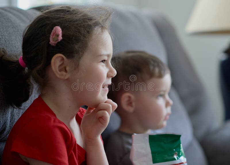 Siblings Eating Chips and Watching TV Stock Image - Image of colorful ...