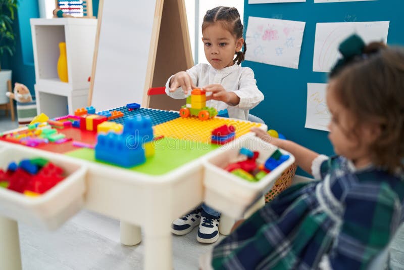 Brother and Sister Playing with Construction Blocks Sitting on Table at ...