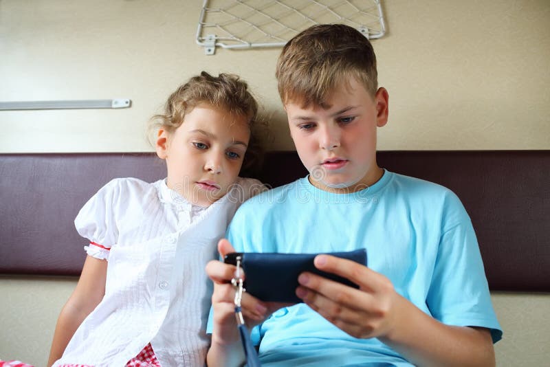 Brother and Sister Playing with the Phone in Stock Image - Image of ...