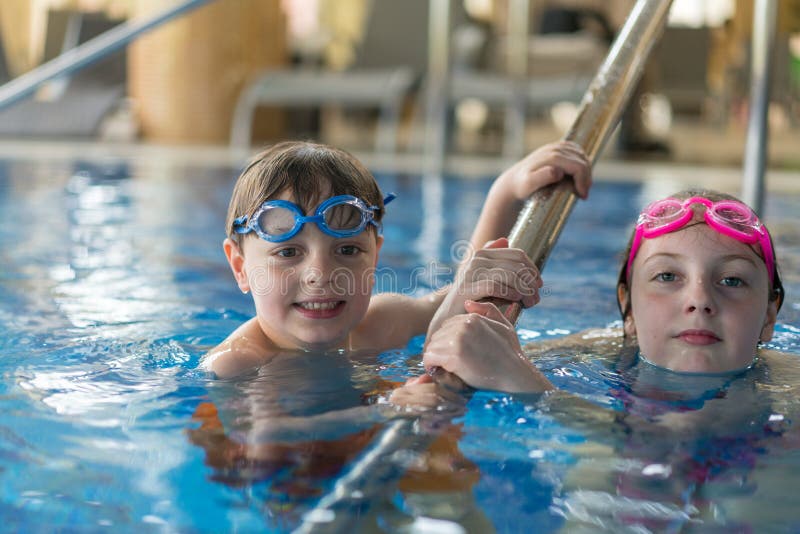 Family having fun in pool stock photo. Image of blue - 246125838