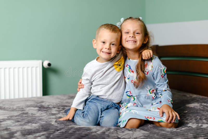 Brother and Sister Relaxing Together in Bed Stock Photo - Image of ...