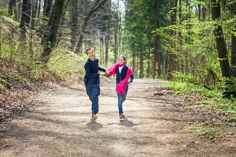 Brother and Sister Running in a Forest Hand in Hand Stock Photo - Image ...