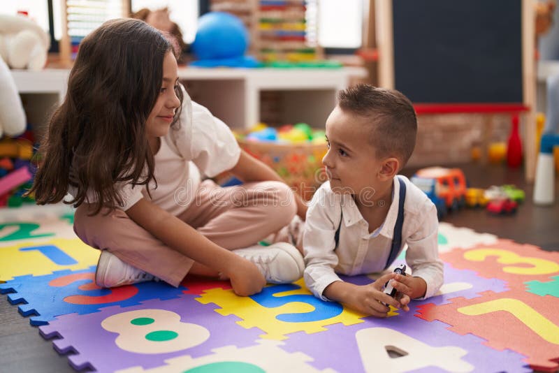 Brother and Sister Smiling Confident Sitting on Floor at Kindergarten ...