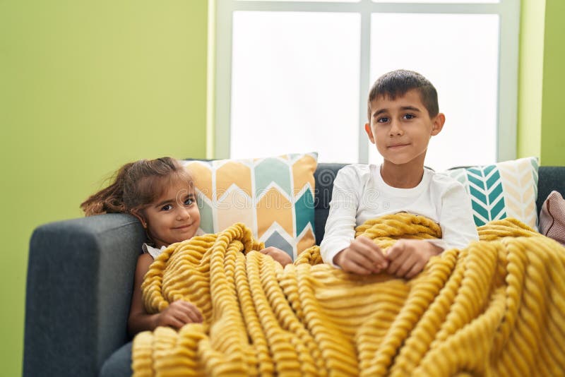 Brother and Sister Smiling Confident Sitting on Sofa at Home Stock ...