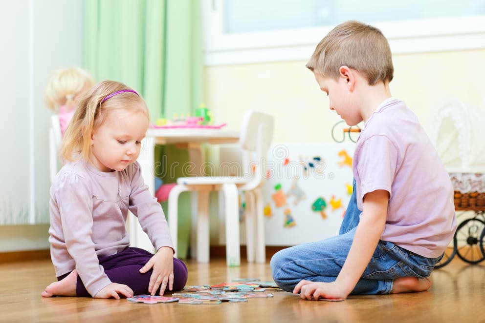 Brother and Sister Solving Puzzle Stock Image - Image of loving, human ...