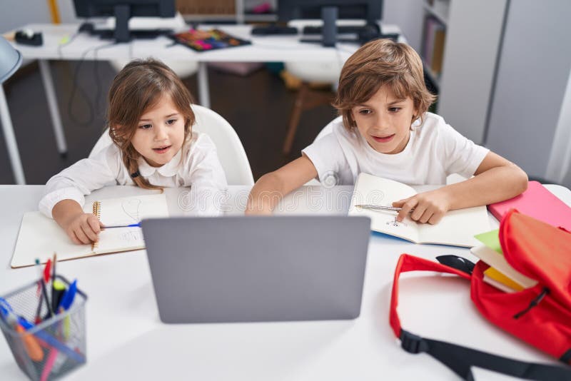 Brother and Sister Students Using Laptop Studying at Classroom Stock ...