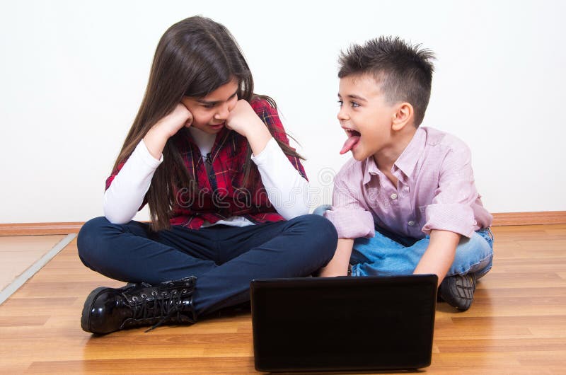 Brother and Sister Using Laptop Stock Photo - Image of elegant ...