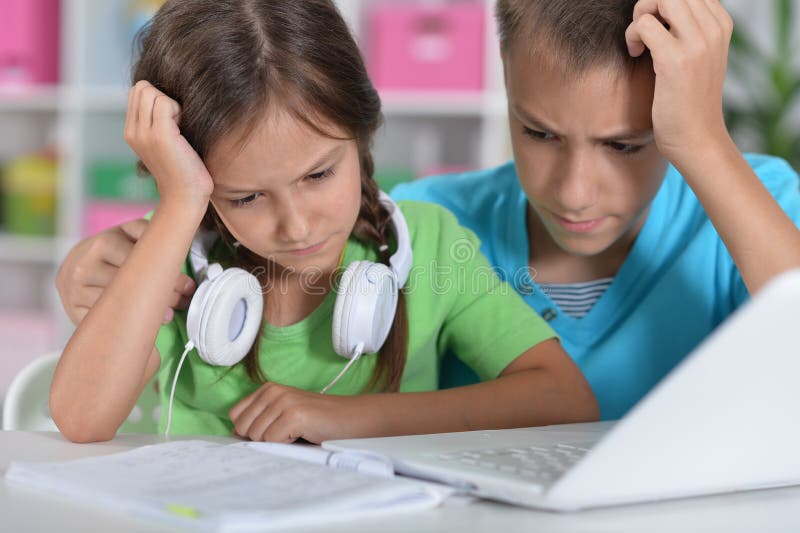 Brother and Sister Using Laptop while Sitting at Table Stock Image ...