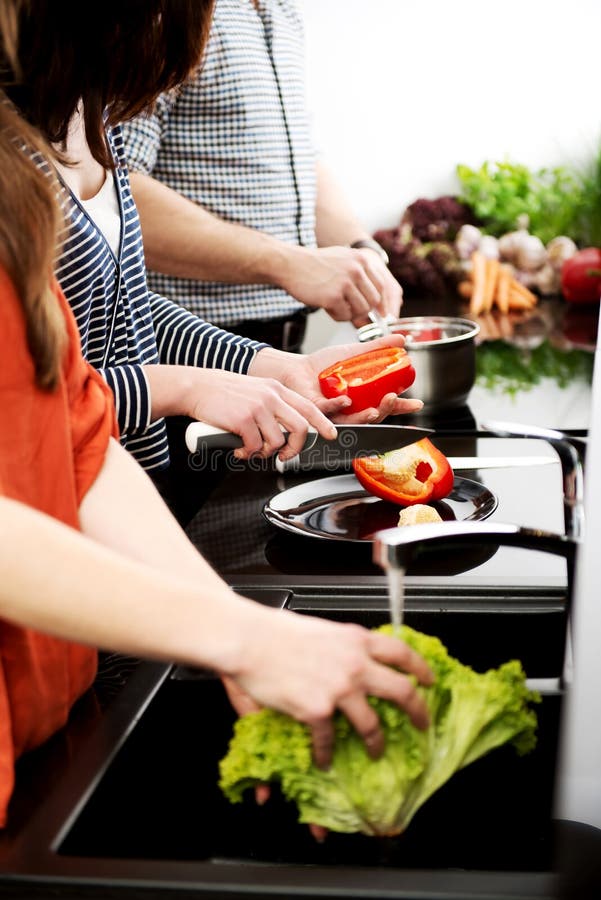 Brother and Sisters Cooking Meal Together. Stock Photo - Image of help ...