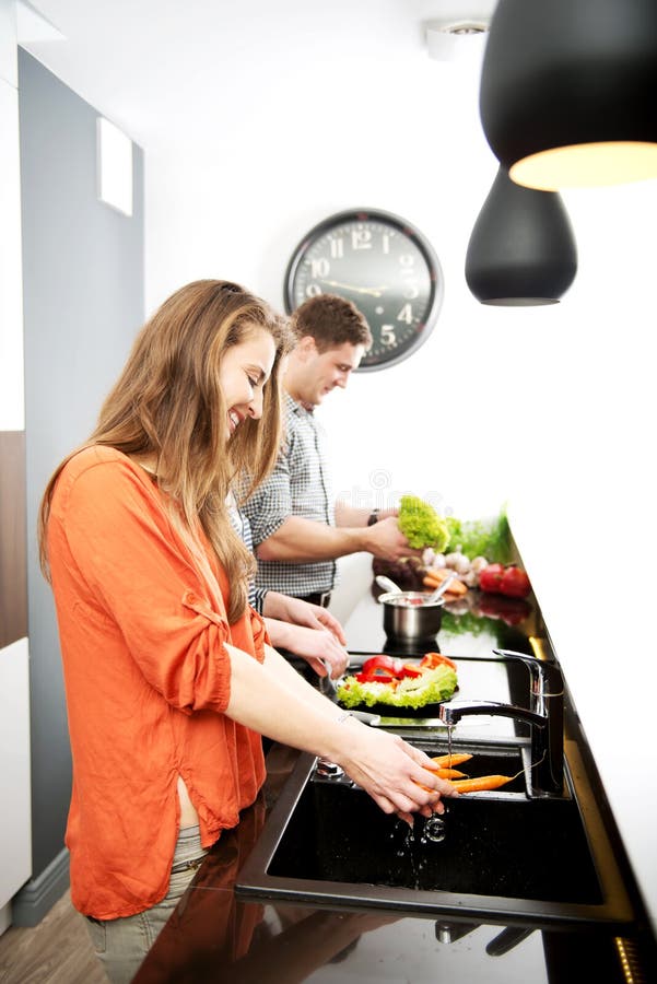 Brother and Sisters Cooking Meal Together. Stock Photo - Image of ...