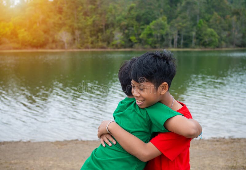 Brothers Hug Each Other by the Reservoir in the Evening Stock Image ...