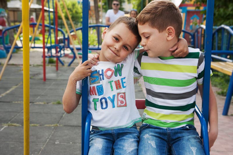 Brothers hug on playground stock photo. Image of childhood - 76803662