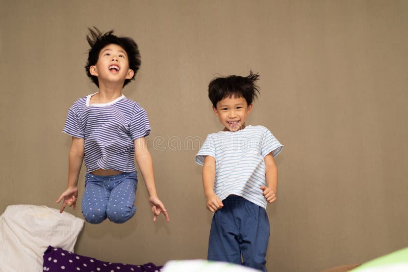 The Brothers are Jumping on the Bed Stock Image - Image of brother ...