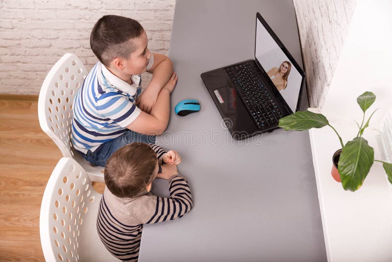 Brothers Looking at Laptop while E-learning. Boys Using Digital Table ...