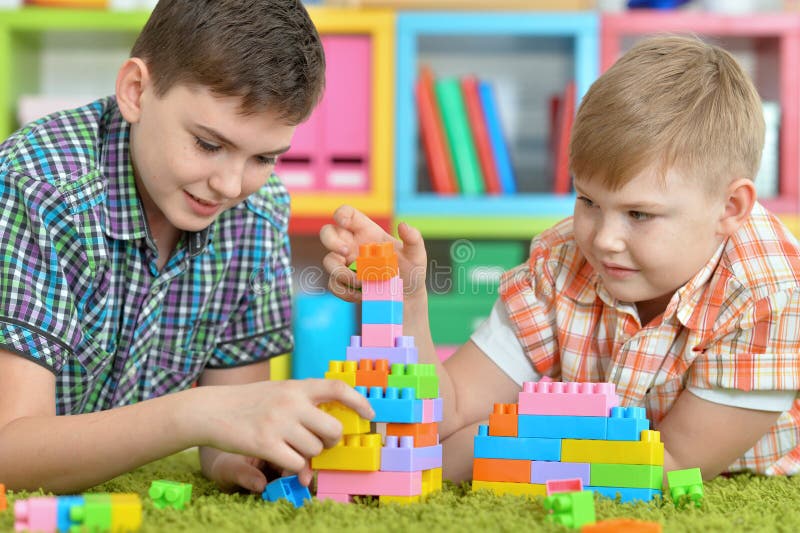 Brothers Playing with Colorful Plastic Blocks in Room Stock Photo ...