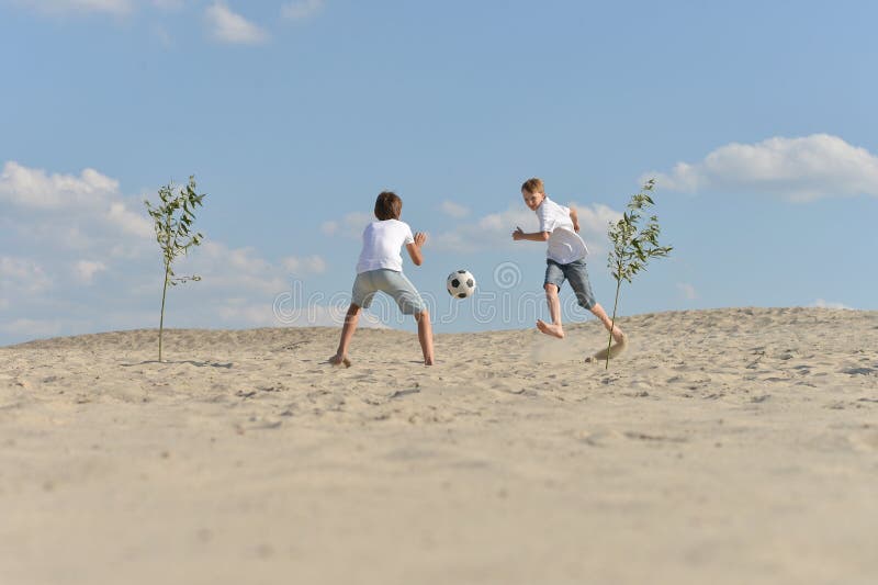 Brothers Playing Football on Beach in Summer Day Stock Photo - Image of ...