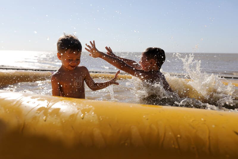 Brothers playing in pool stock image. Image of friend - 126936841