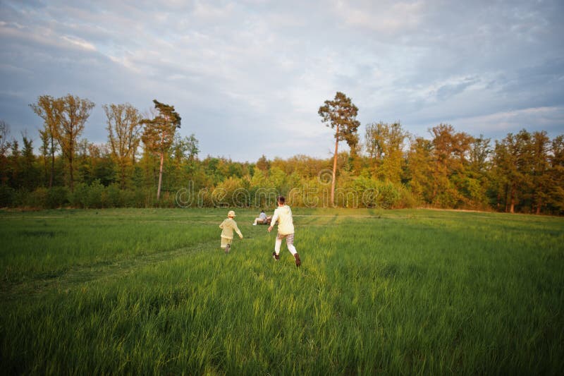 Brothers Running and Having Fun Together at Meadow Stock Photo - Image ...