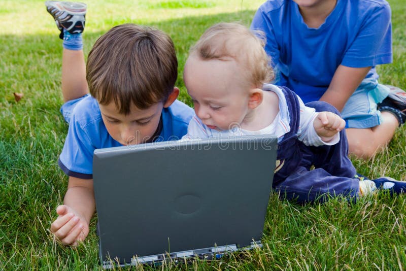 Brothers study on computer stock photo. Image of grass - 2934484