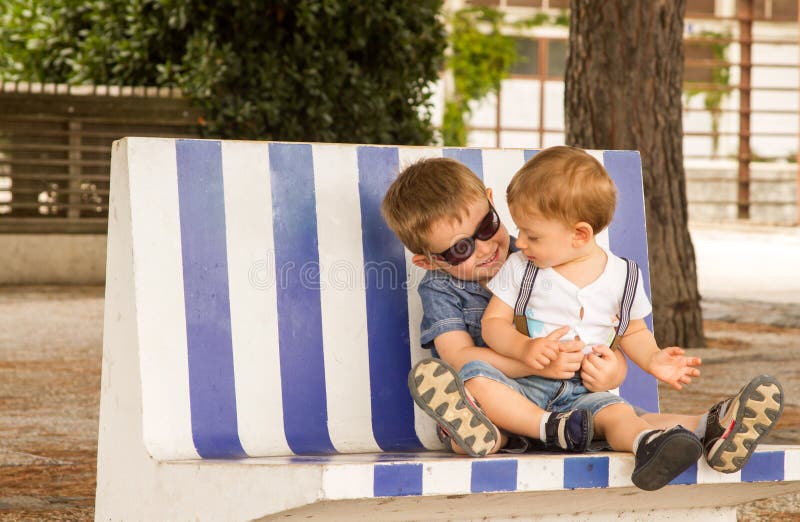 Brothers on bench stock image. Image of children, little - 65242869