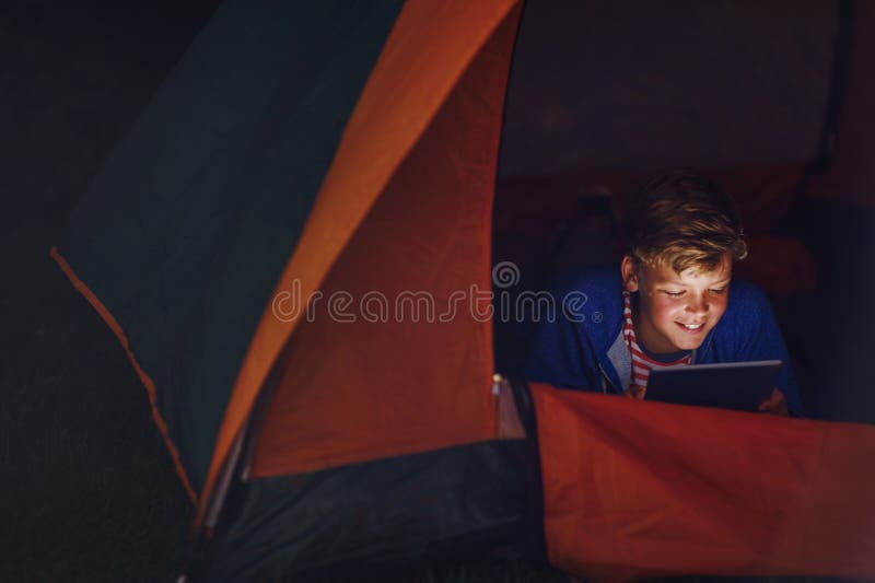 He Brought Some Entertainment Along To Camp. a Young Boy Using a ...