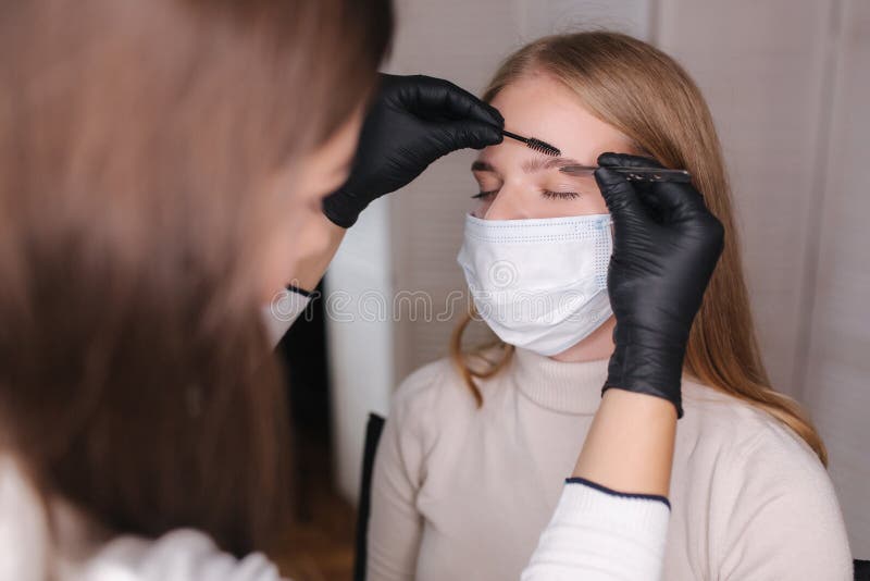 Brow and Makeup Master in Protective Mask Gives Shape To Pull Out with ...