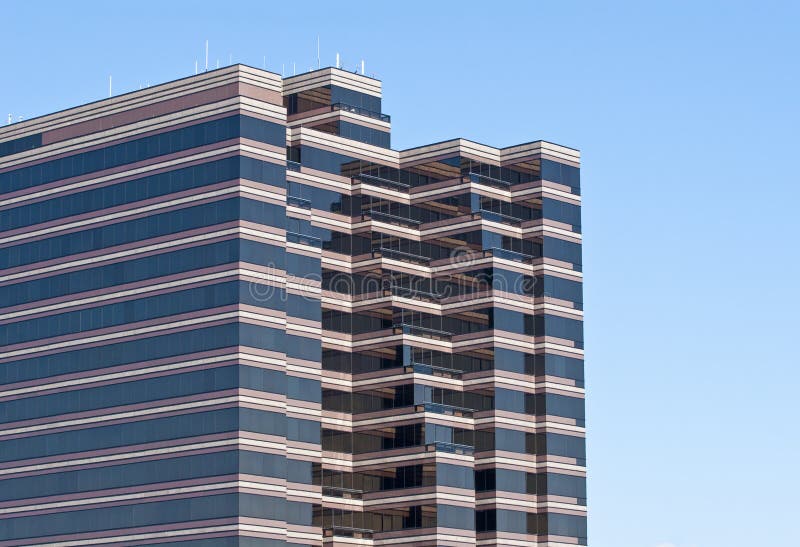 Brown Striped Glass Tiered Building on Blue Stock Image - Image of ...