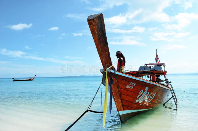 Brown Boat Docked At The Seaside Under The Clear Blue Skies Stock Photo ...