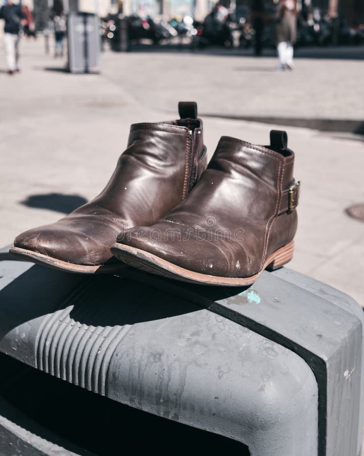 Brown Boots Abandoned on an Urban Trash Can Stock Image - Image of ...