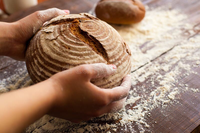 Brown bread in hands stock image. Image of round, fresh - 80640997