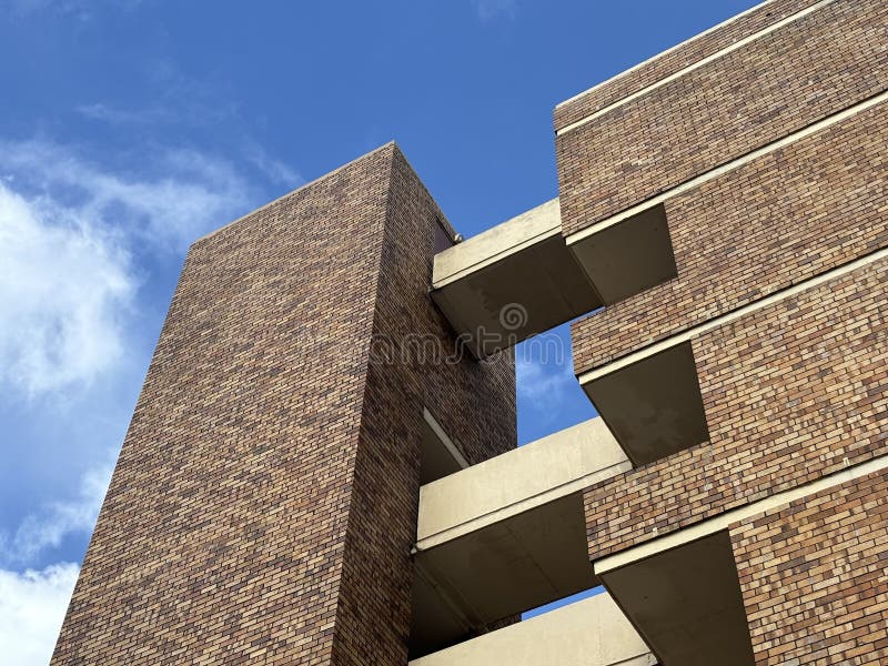 This is a Brown Building that Has Many Different Levels and Shapes ...