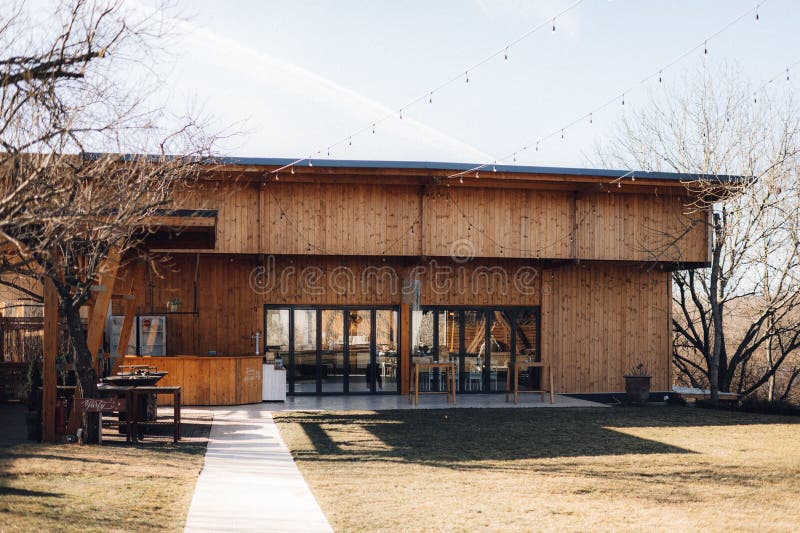 Brown Building with Large Windows and a Spacious Patio Area in Front of ...