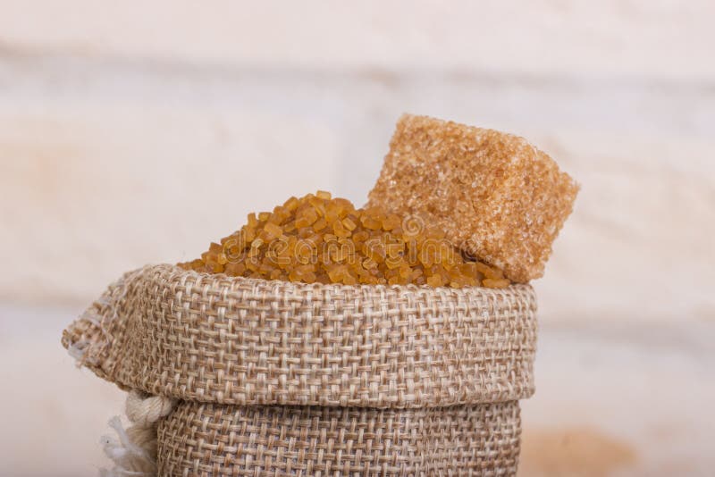 Brown Cane Sugar in a Bag with a Cube of Shed on Top Stock Image ...