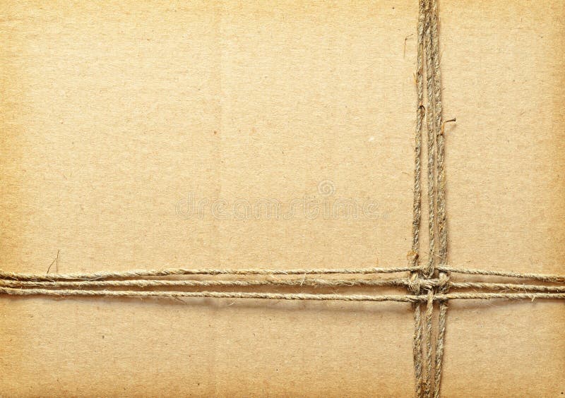 Cardboard Box Tied With String On A Bow On A Wooden Background In ...
