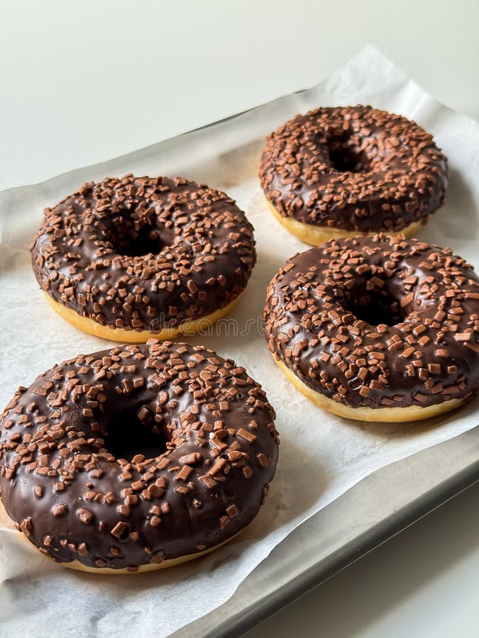 Brown Chocolate Donuts on Metal Tray and White Table Side View Stock ...