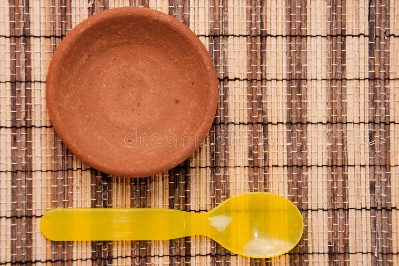 Brown Clay Disk with Yellow Plastic Spoon Stock Image - Image of market ...
