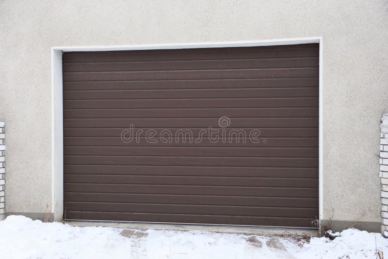 Brown Closed Gate on the Facade of a Garage Outside in the Snow Stock ...