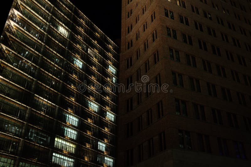 Brown Concrete Building beside Black Concrete Building during Night ...