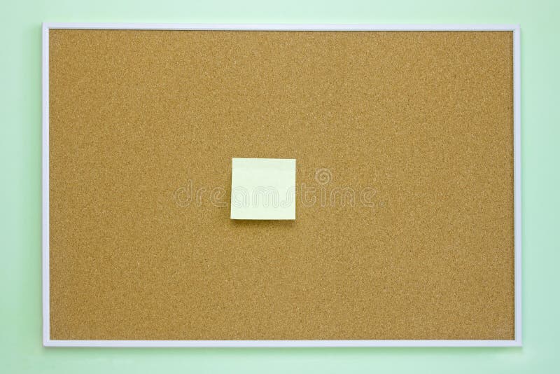 Brown Cork Message Board with Yellow Stick Note on the Light Green or ...
