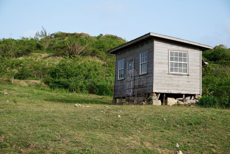 Brown Cottage on Top of a Hill Covered with Vibrant Green Grass and ...
